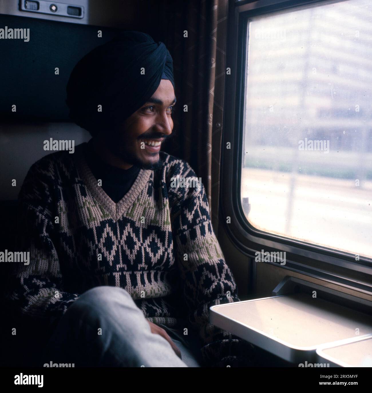 African with turban in train compartment Stock Photo - Alamy