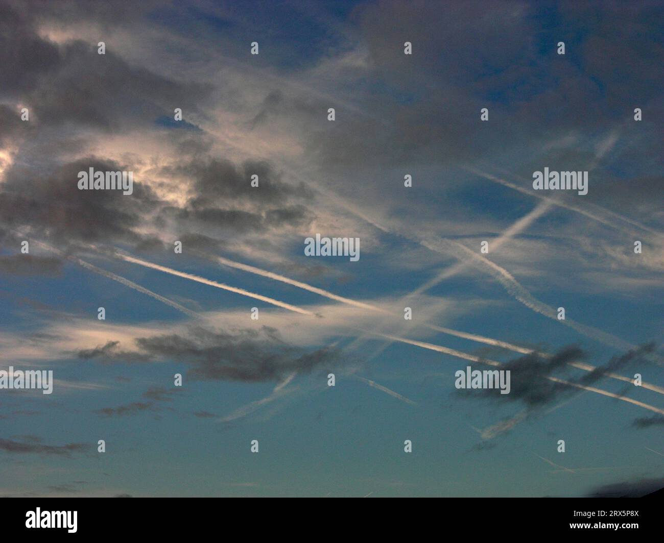 Condensation trails in the sky from jets, aircraft Stock Photo - Alamy
