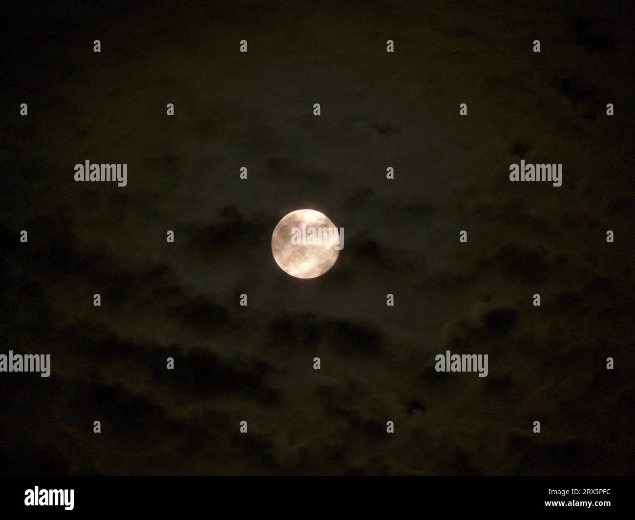 Full moon at night behind clouds Stock Photo - Alamy