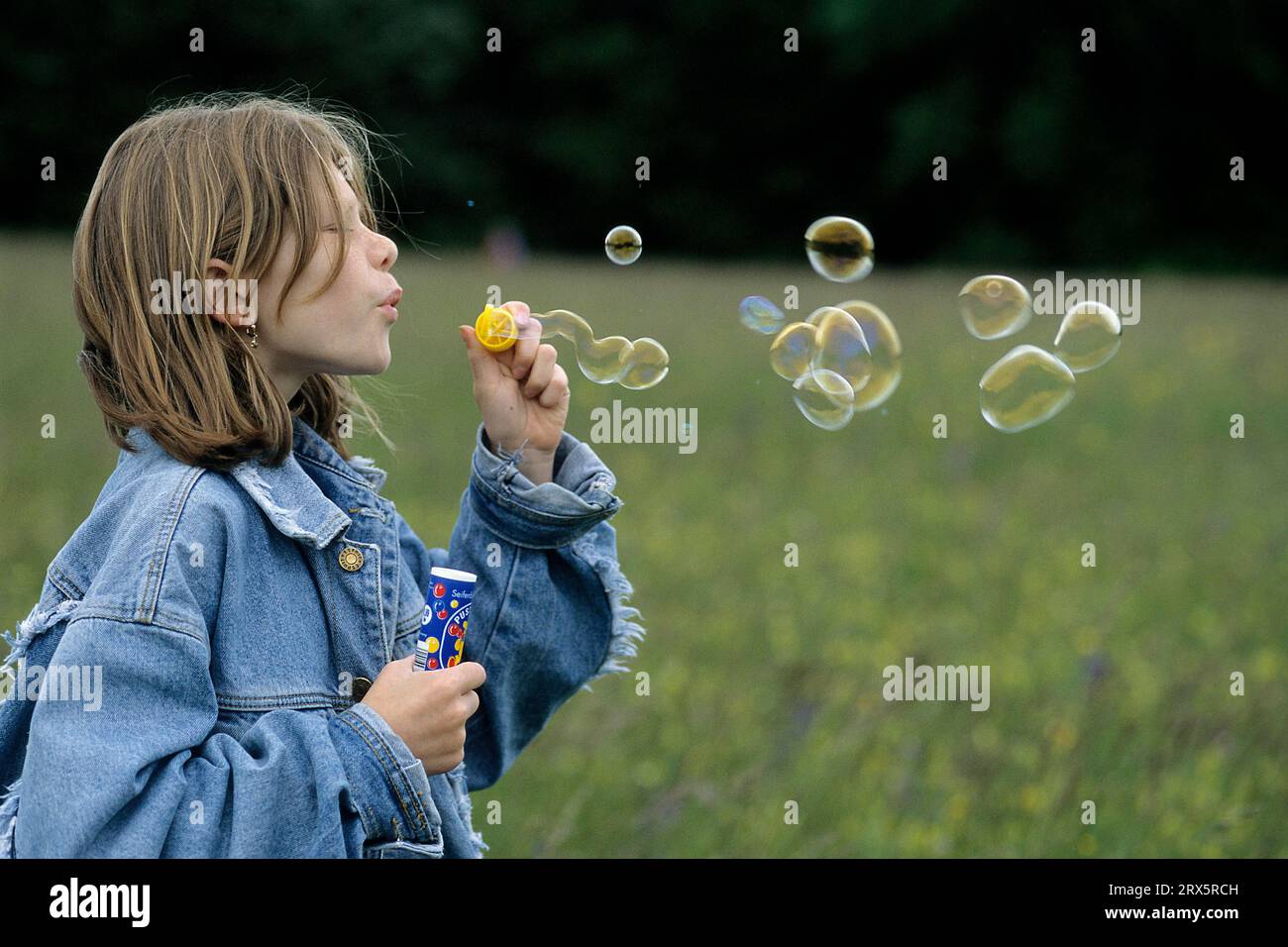 Girl making soap bubbles hi-res stock photography and images - Alamy
