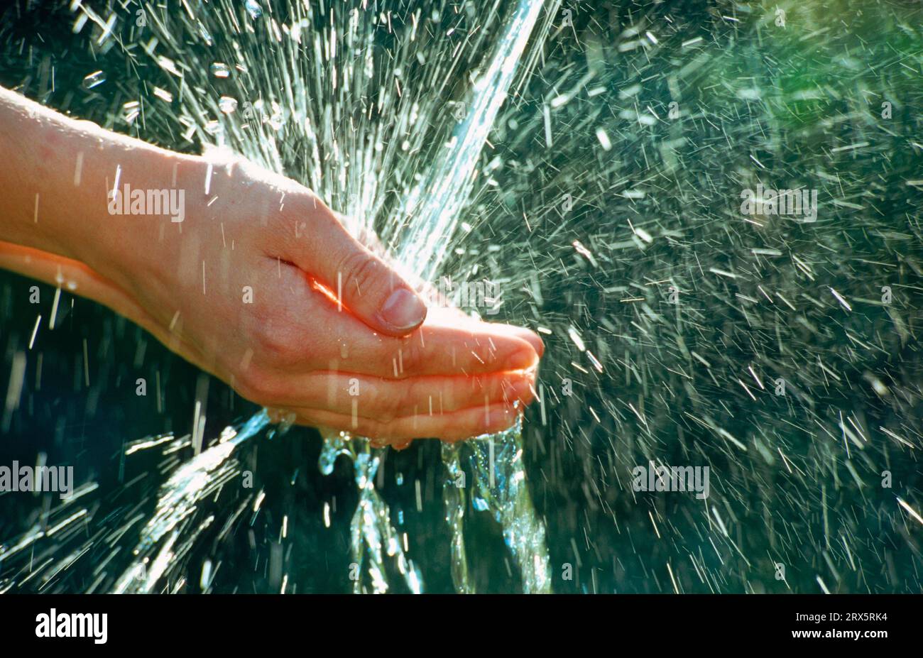 Water splashes into children's hands Stock Photo - Alamy