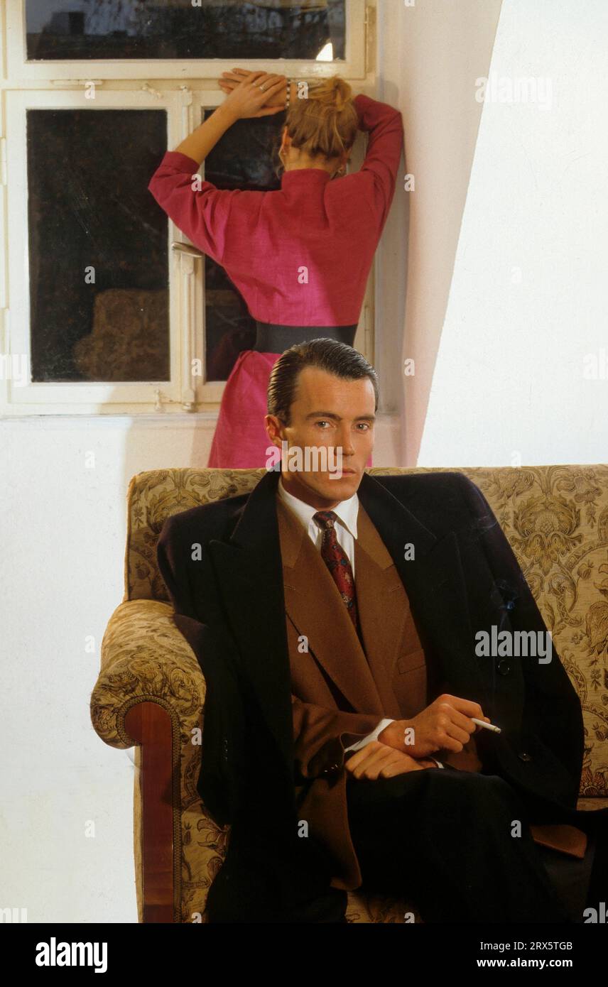 Couple arguing, scene, He smoking cigarette, She standing crying at the ...