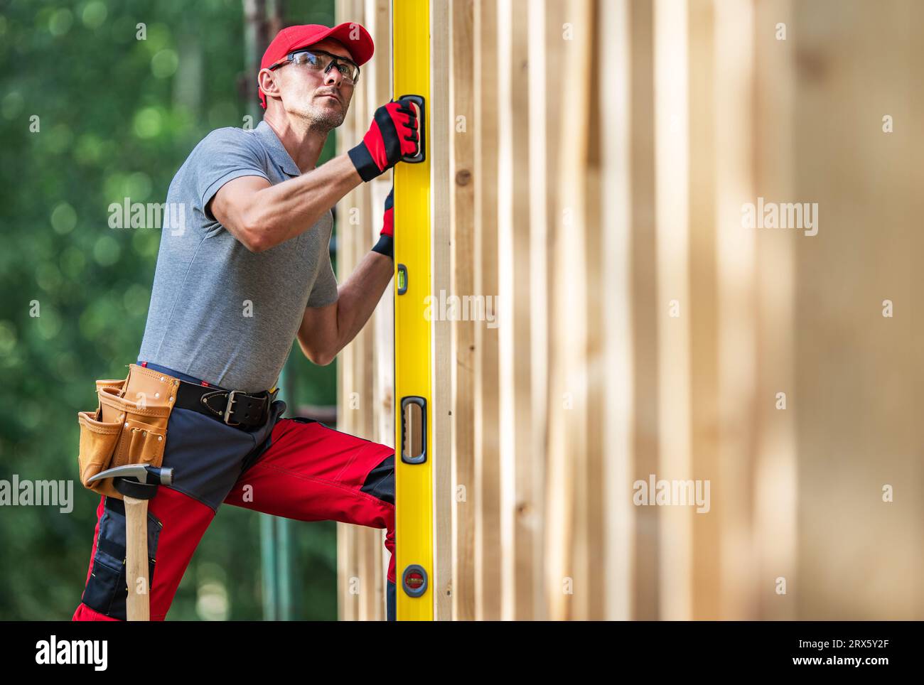 Construction Worker with Bubble Spirit Level Checking on Vertical Wooden Skeleton Frame Levels ...