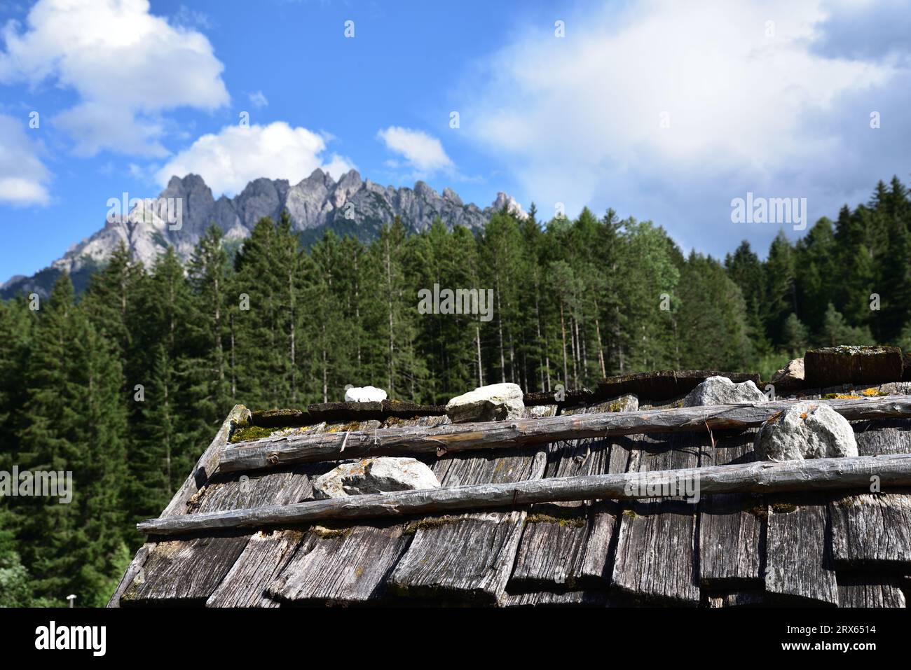 Ancient rustic roof of a mountain hut with the Baranci mountain group ...