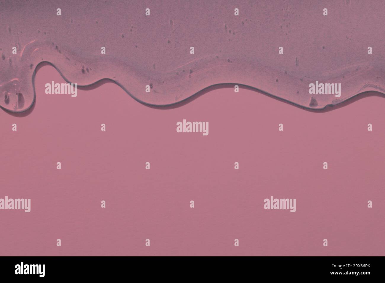 viscous pure transparent cosmetic gel on pink background. tactile , skincare, cosmetics concept ...