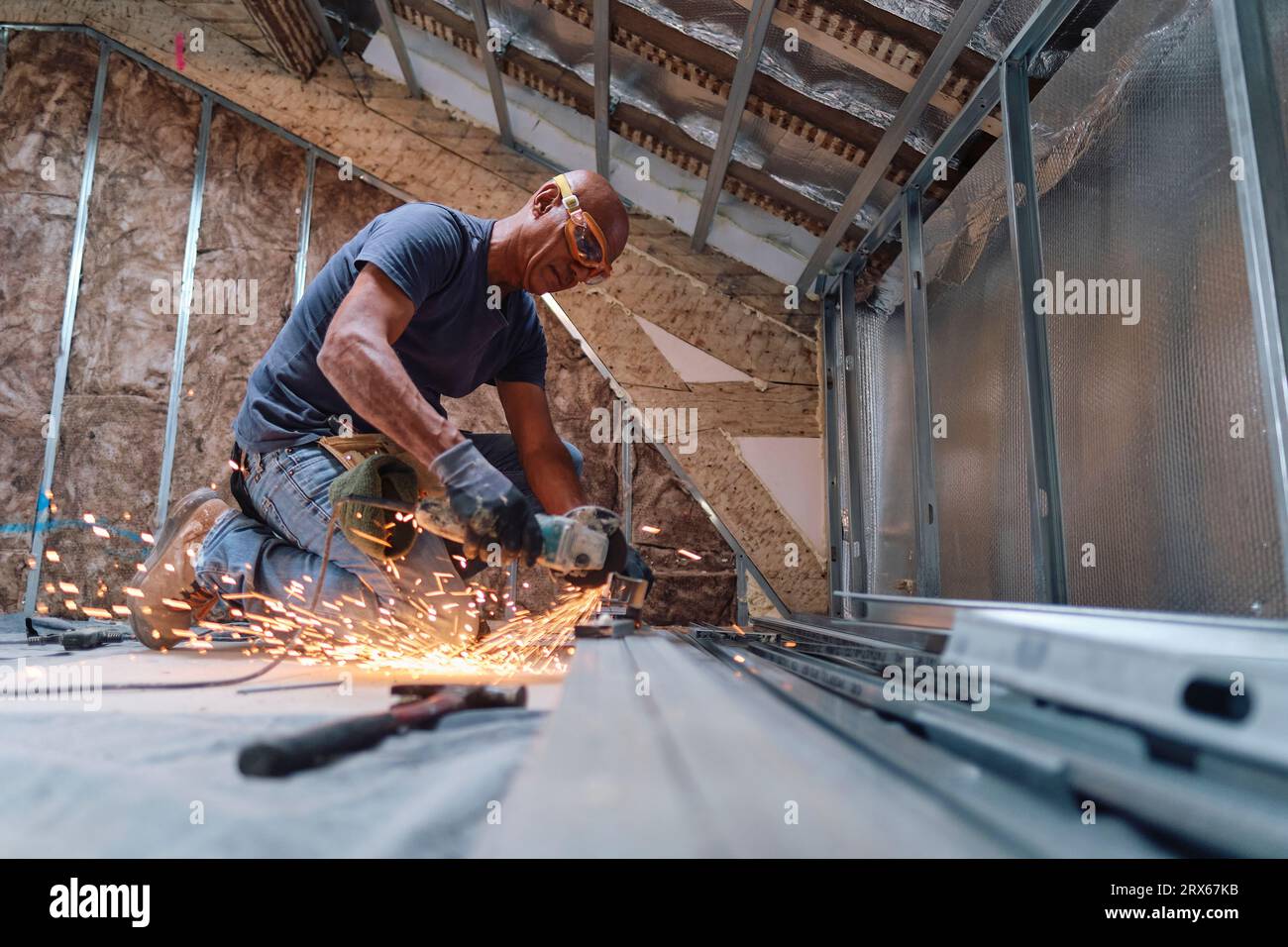 Mature construction worker cutting metal with circular hand saw Stock ...