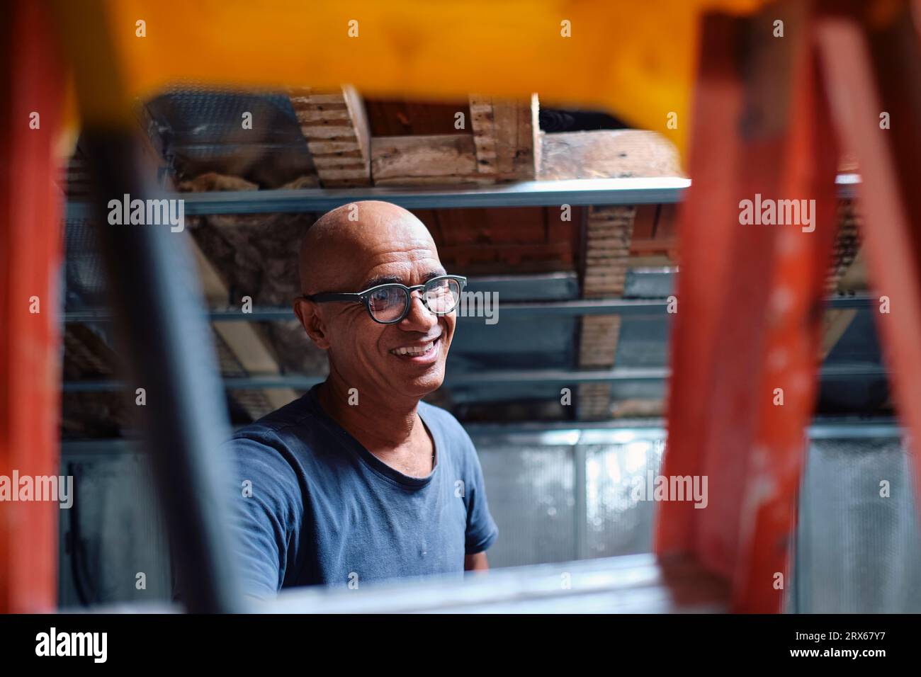 Happy construction worker wearing eyeglasses at site Stock Photo - Alamy