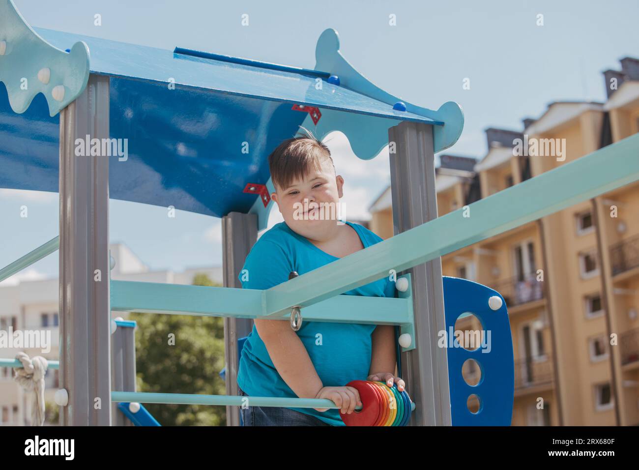 Smiling boy with down syndrome plays on playground Stock Photo - Alamy