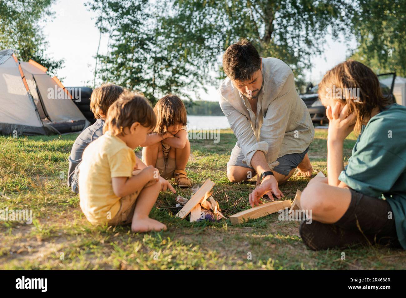 Children with father preparing for bonfire on grass Stock Photo - Alamy