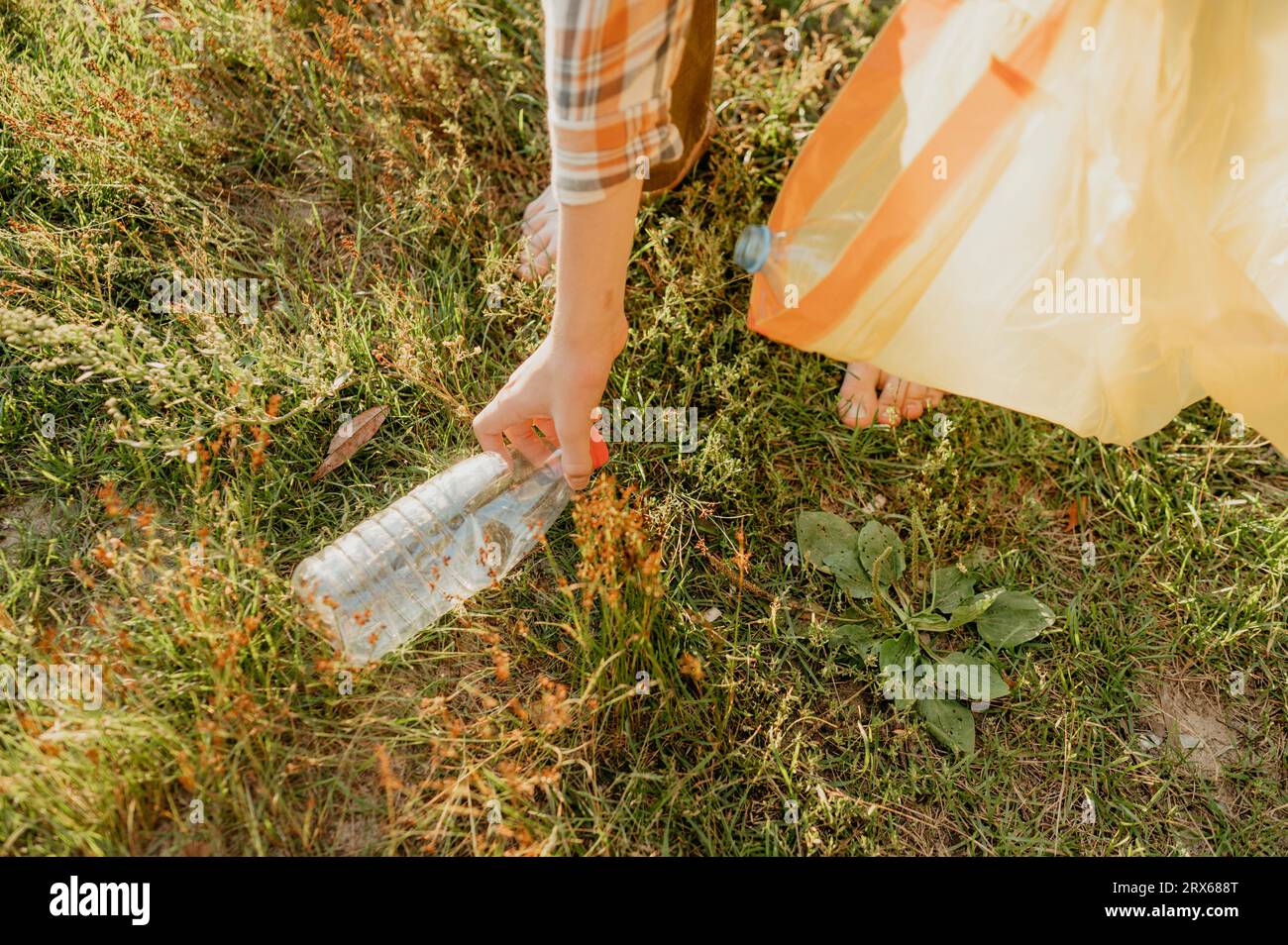 Hand picking up plastic bottle hi-res stock photography and images - Alamy