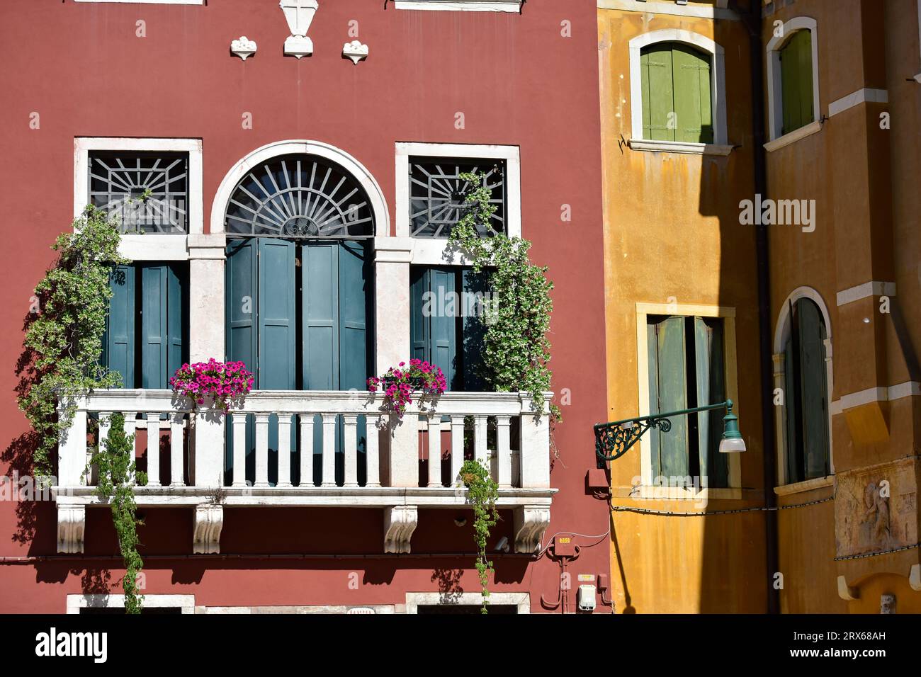 Italy, Veneto, Venice, Flowers on balcony with shuttered windows Stock ...