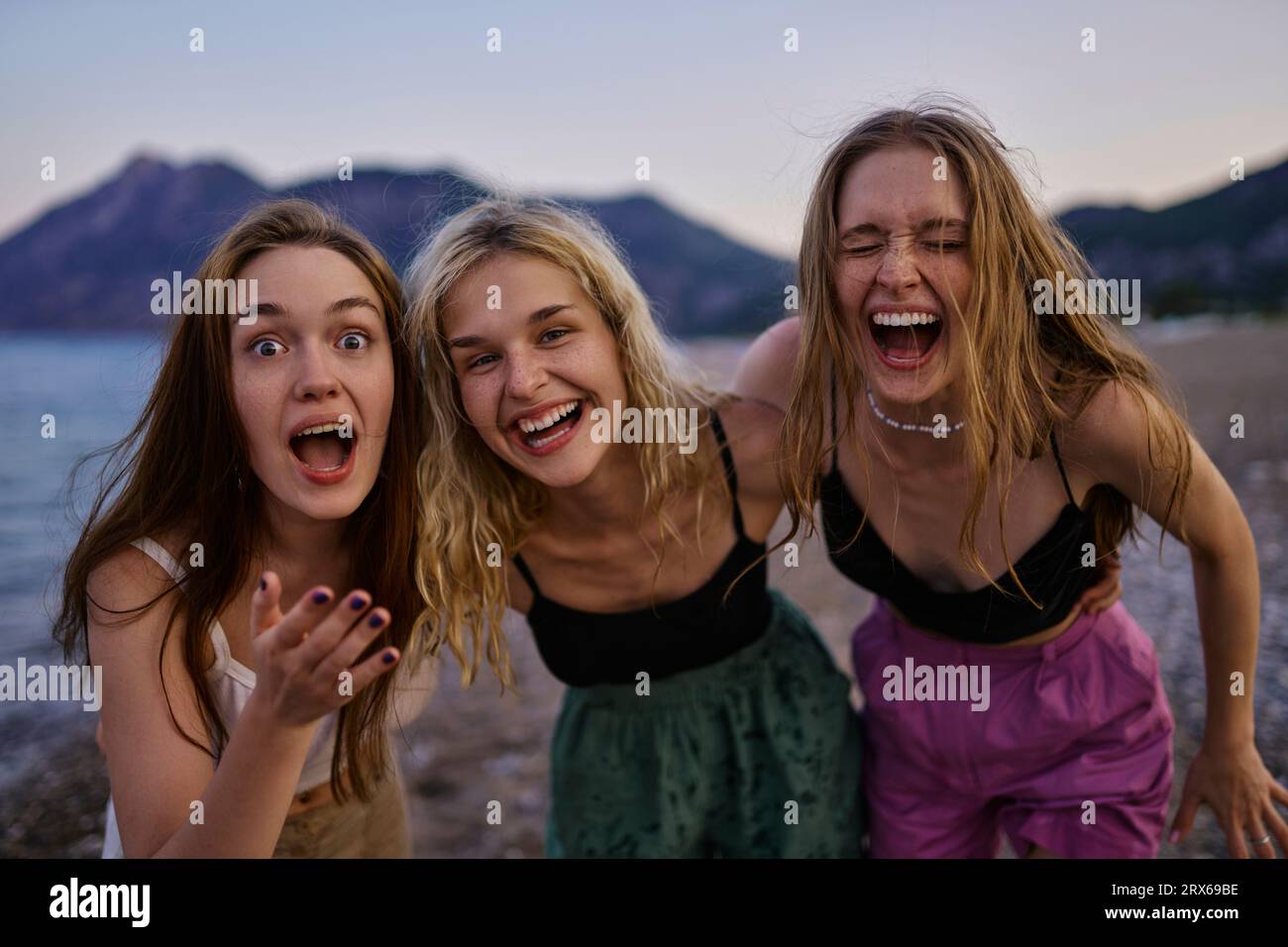 Cheerful friends laughing at beach on vacation Stock Photo - Alamy