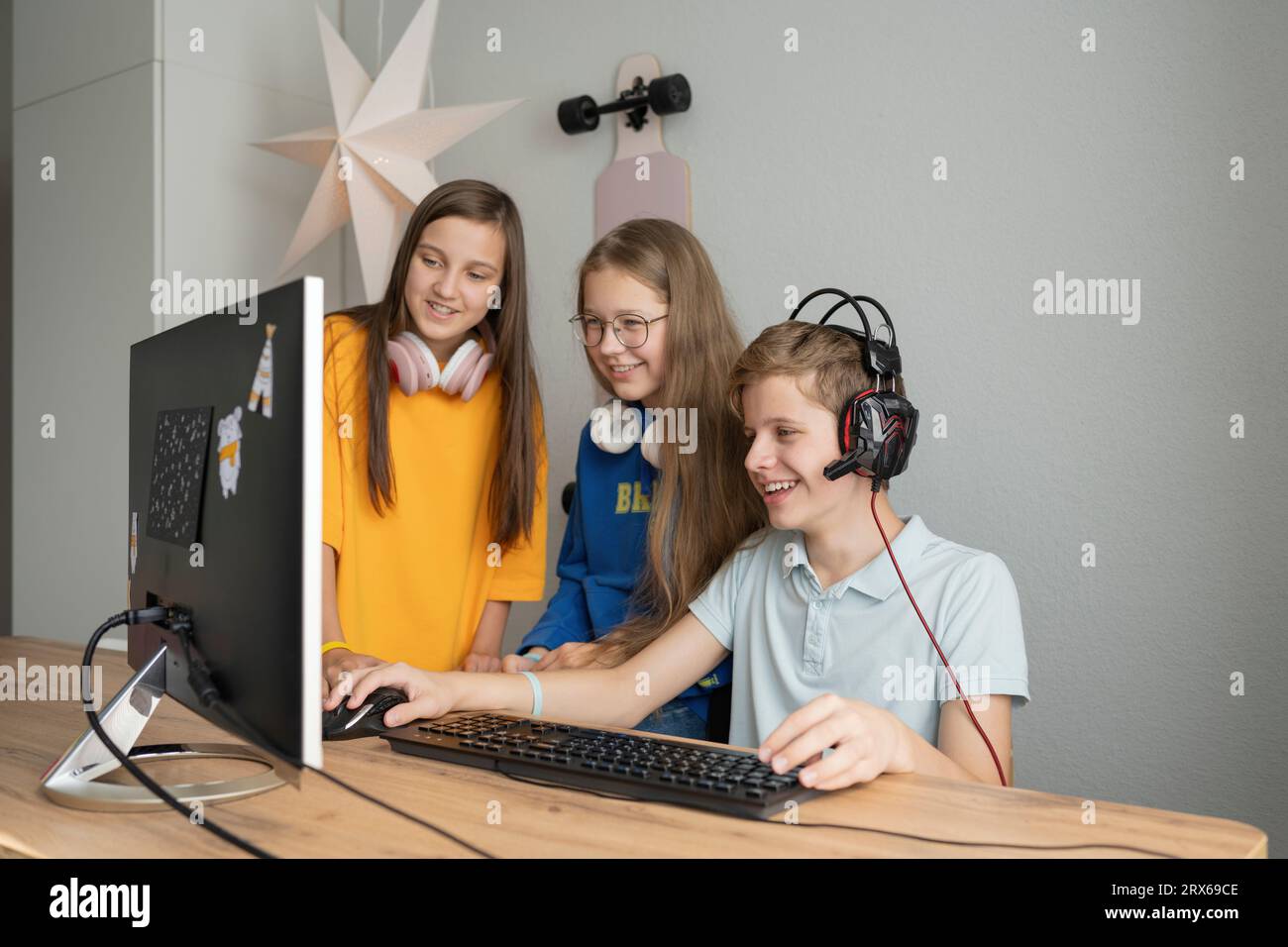 Boy and girl at computer headphones hi-res stock photography and images ...