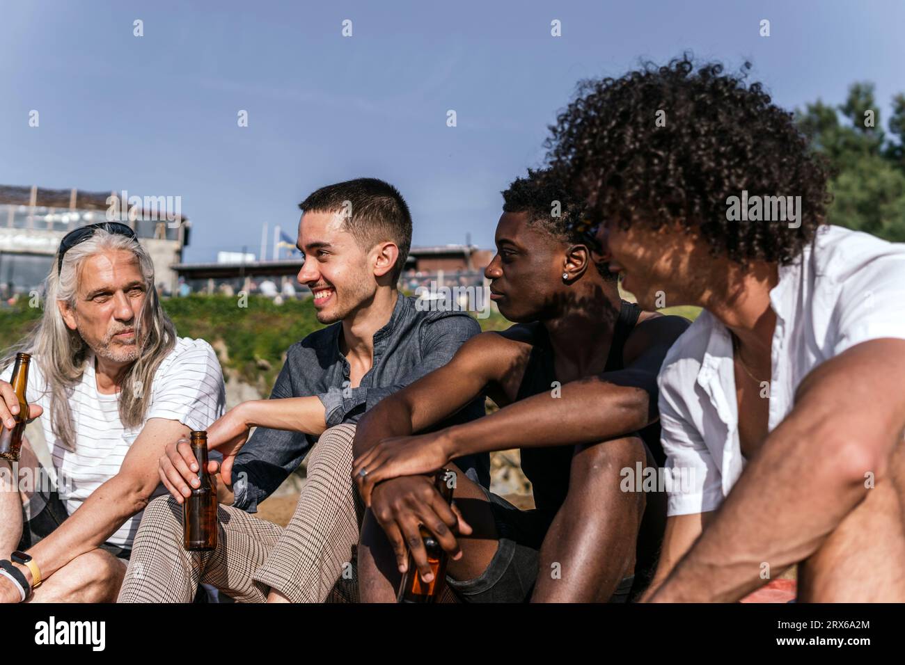 Male friends having beer together hi-res stock photography and images ...