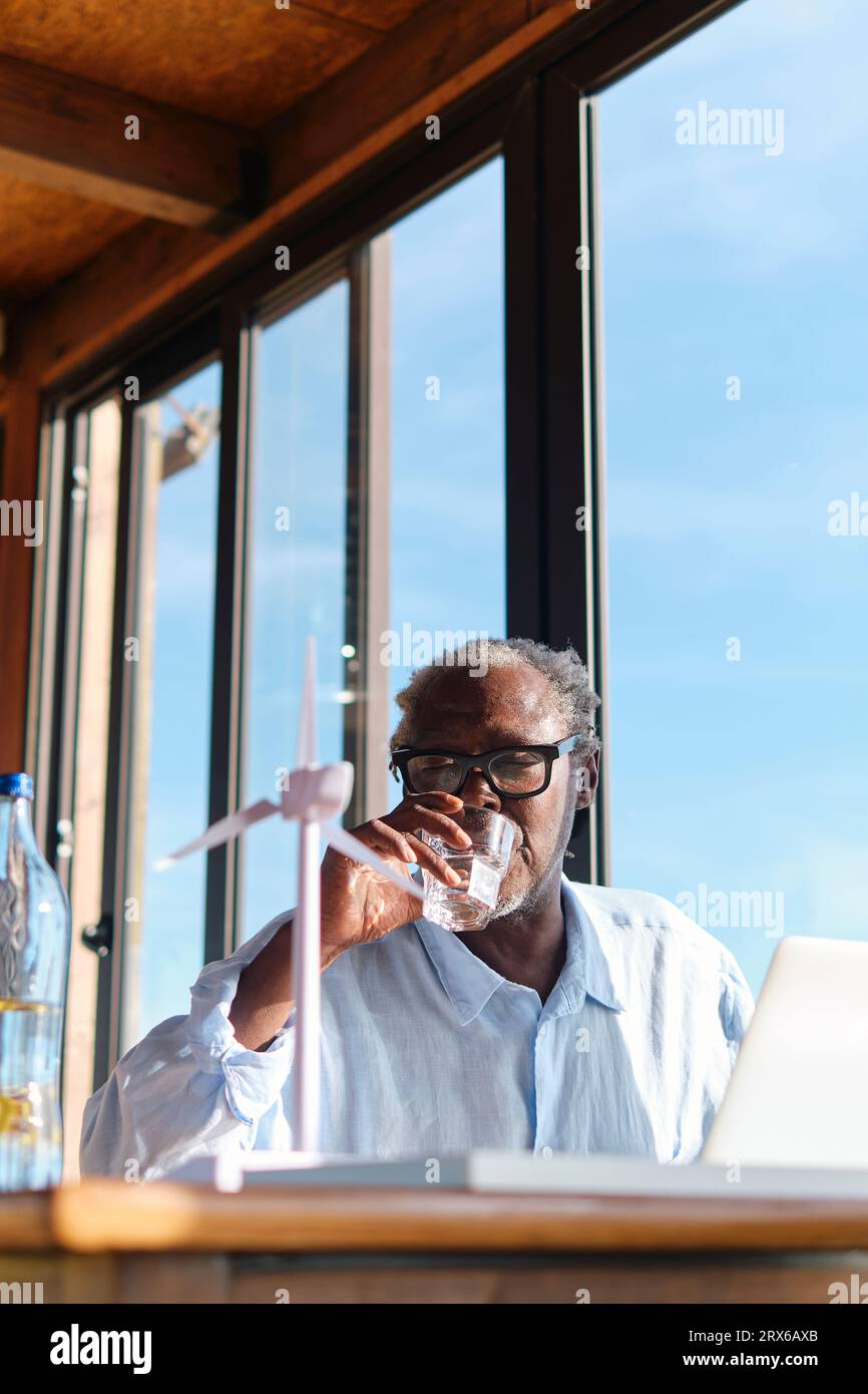 Engineer drinking water and sitting in restaurant Stock Photo - Alamy