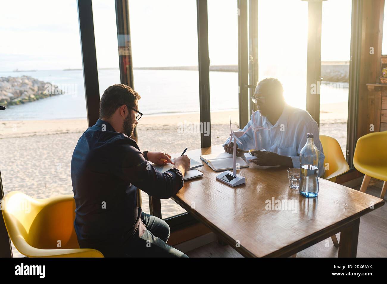 Engineers working and having discussion together in cafe Stock Photo ...