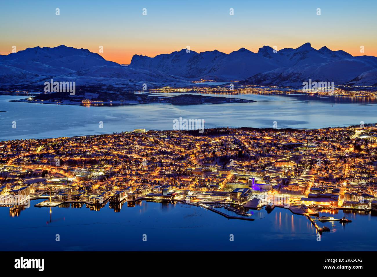 Norway, Troms og Finnmark, Tromso, Long exposure of illuminated city ...