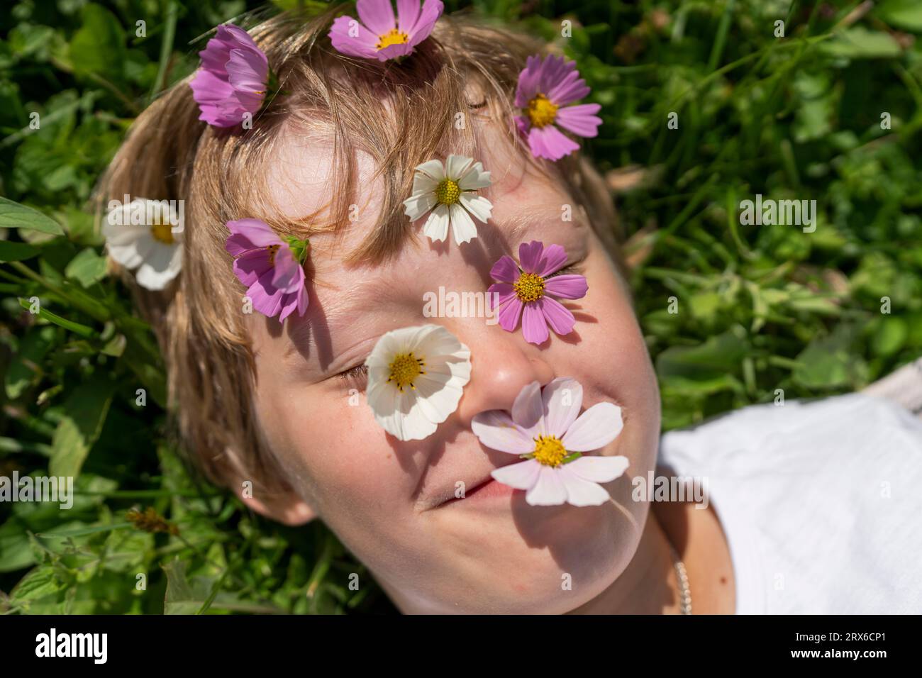 Boy lying on grass flowers hi-res stock photography and images - Alamy