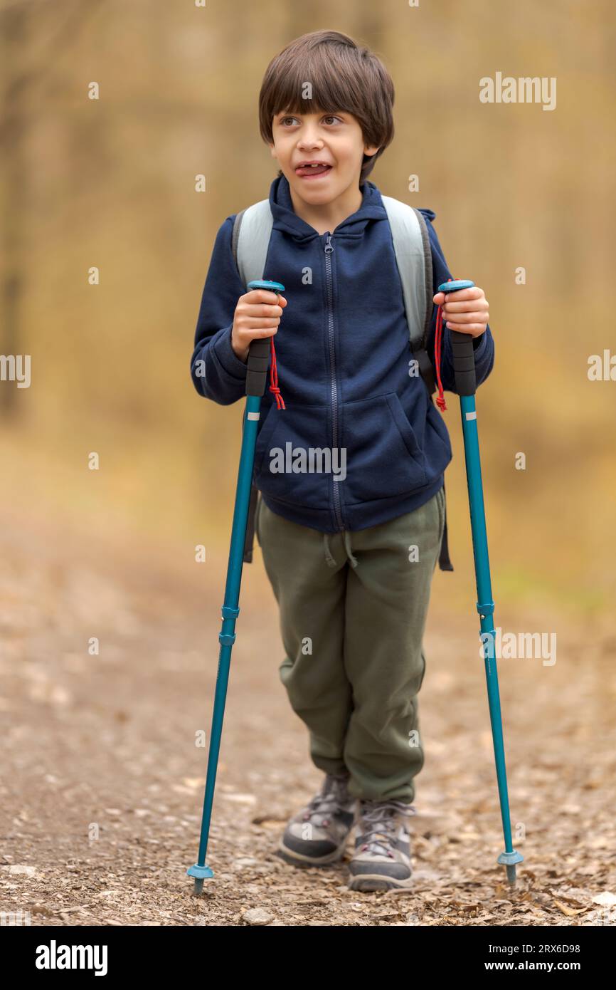 Cute toothless boy enjoying treking in woods Stock Photo - Alamy