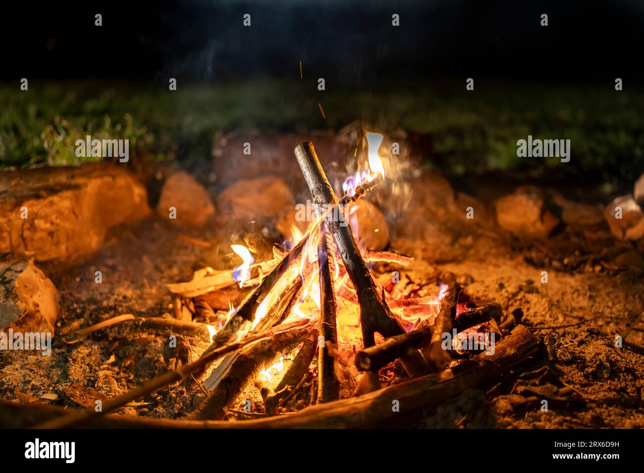 Campfire at night in mountains Stock Photo - Alamy