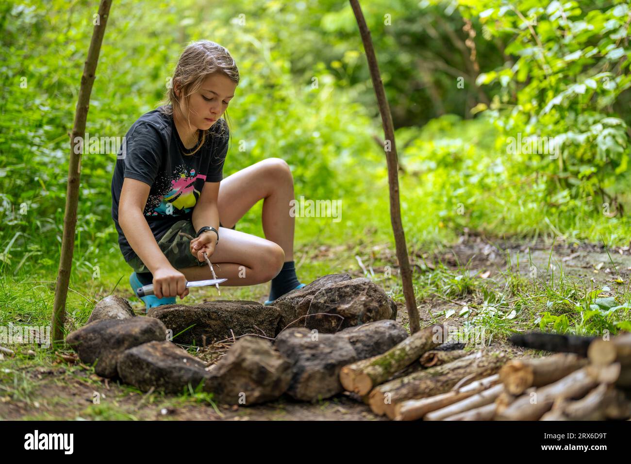 Cute boy preparing chips to start a fire. Food preparation into the ...
