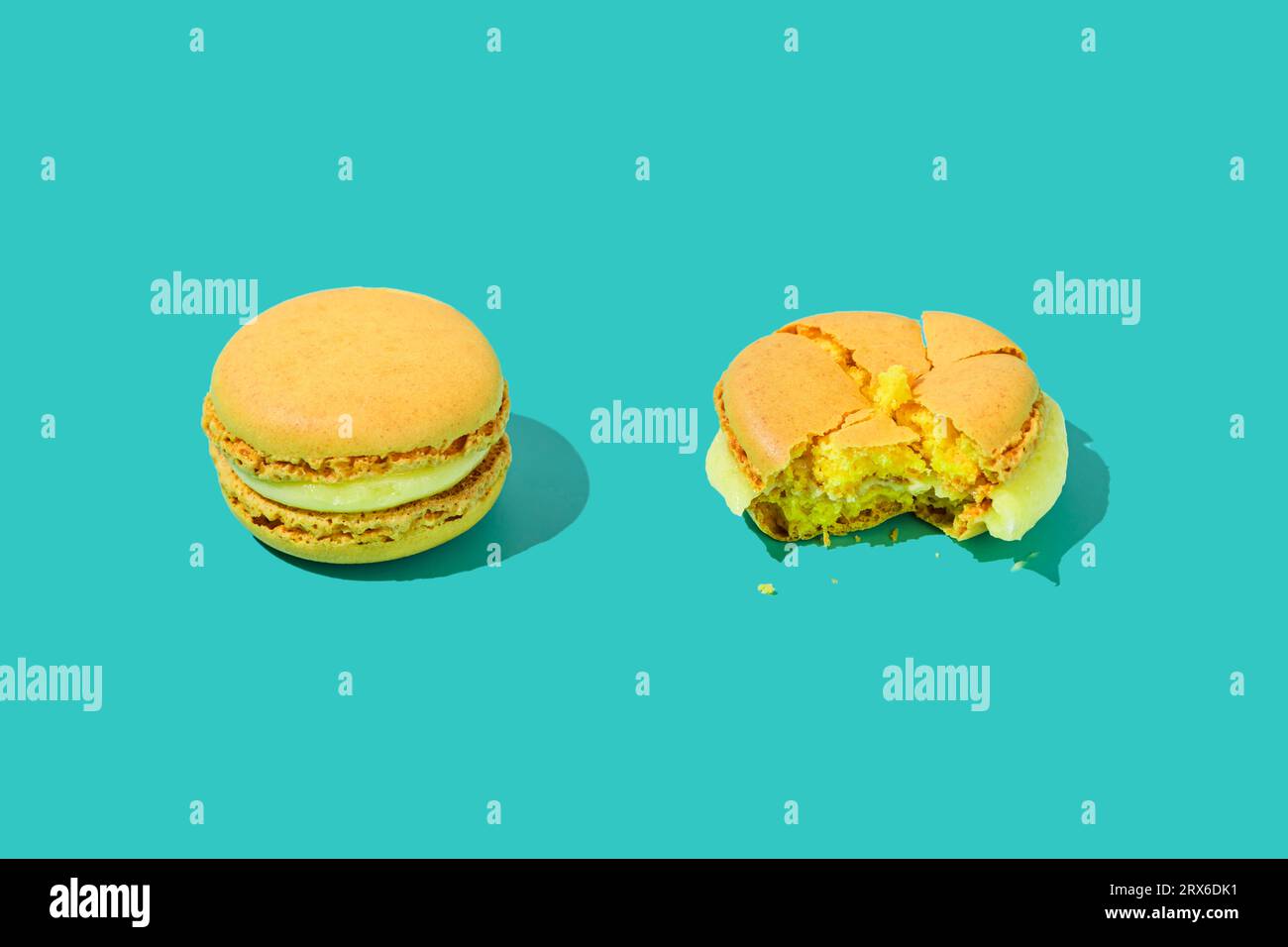 Crushed and full macaroon on turquoise background Stock Photo - Alamy
