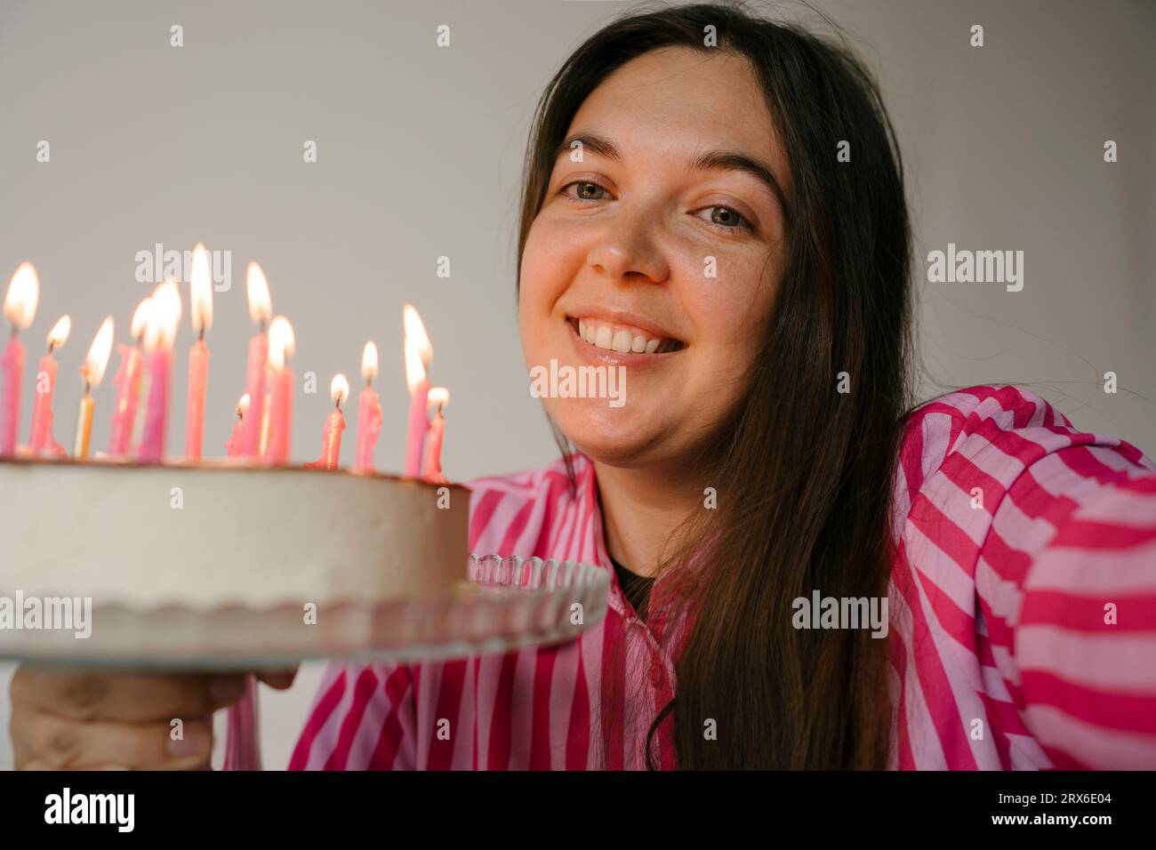 Smiling woman eating birthday cake hi-res stock photography and images ...