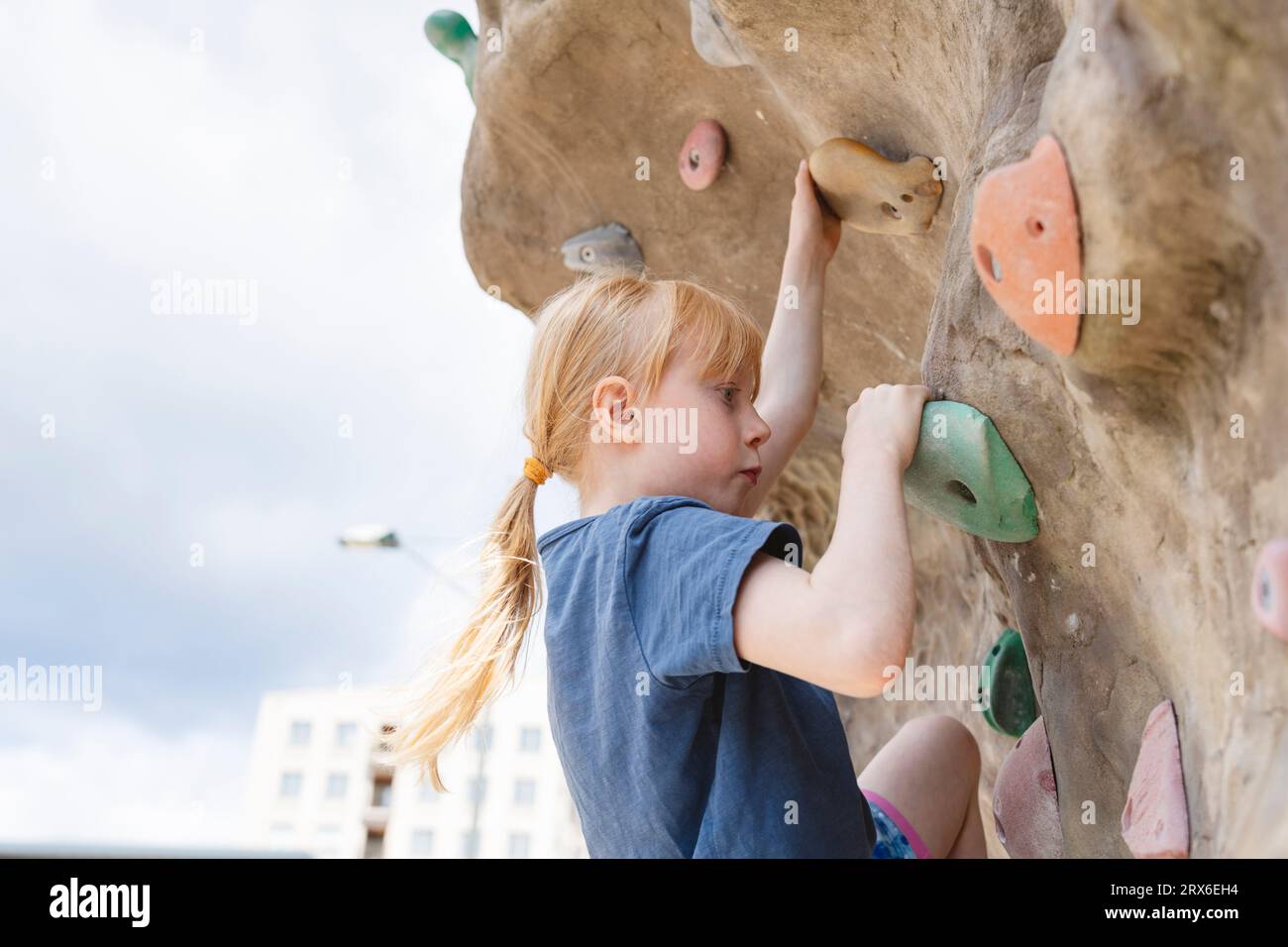 Girl climbing rock wall at playground Stock Photo - Alamy