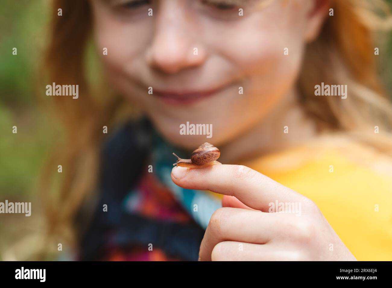 Girl with small snail on finger Stock Photo - Alamy