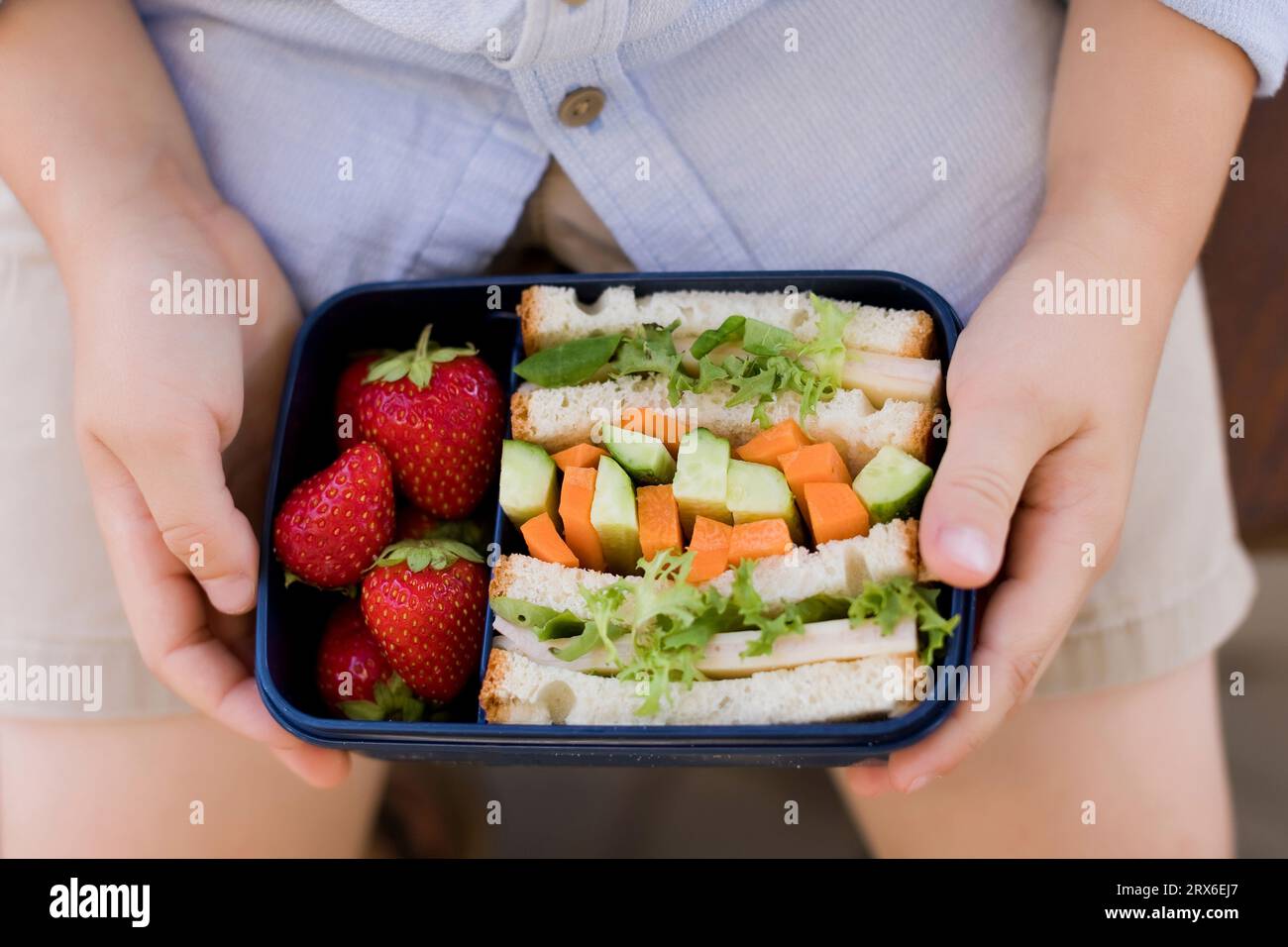 Boy holding a box hi-res stock photography and images - Alamy