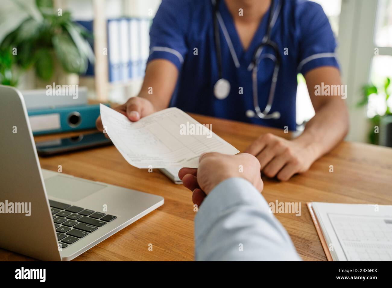 Hand of doctor giving prescription to patient over desk in office Stock ...