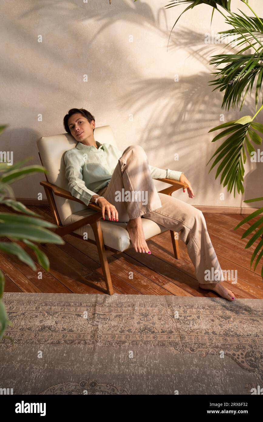 Woman sitting in armchair barefoot hi-res stock photography and images ...
