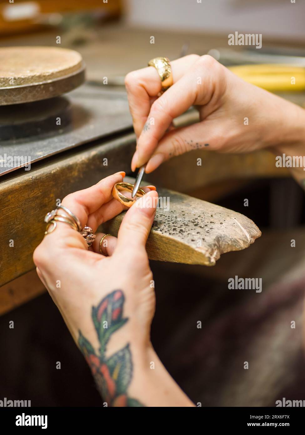 Hands of goldsmith making ring with work tool at workshop Stock Photo ...