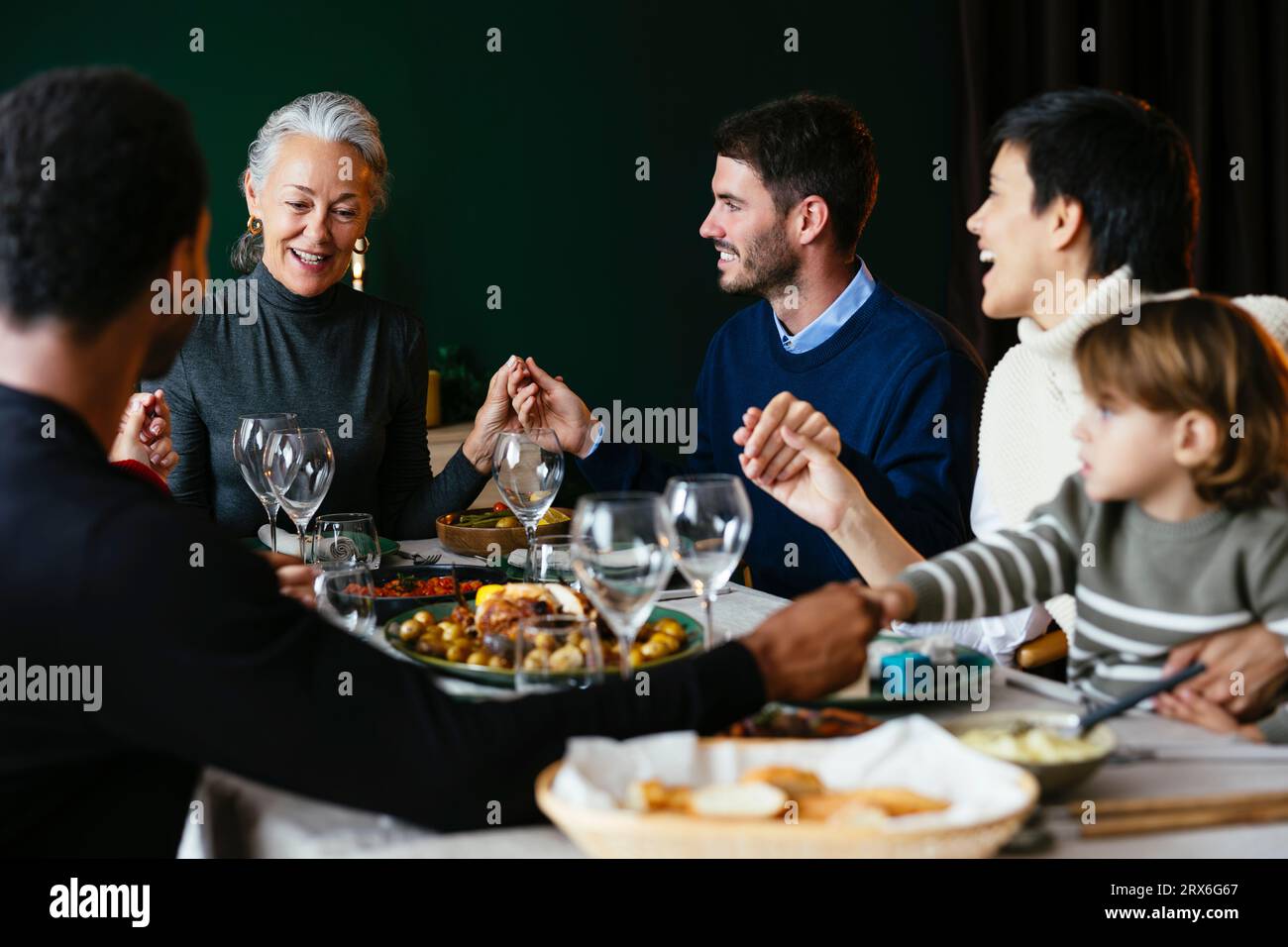 Multiracial family having dinner together at home Stock Photo - Alamy