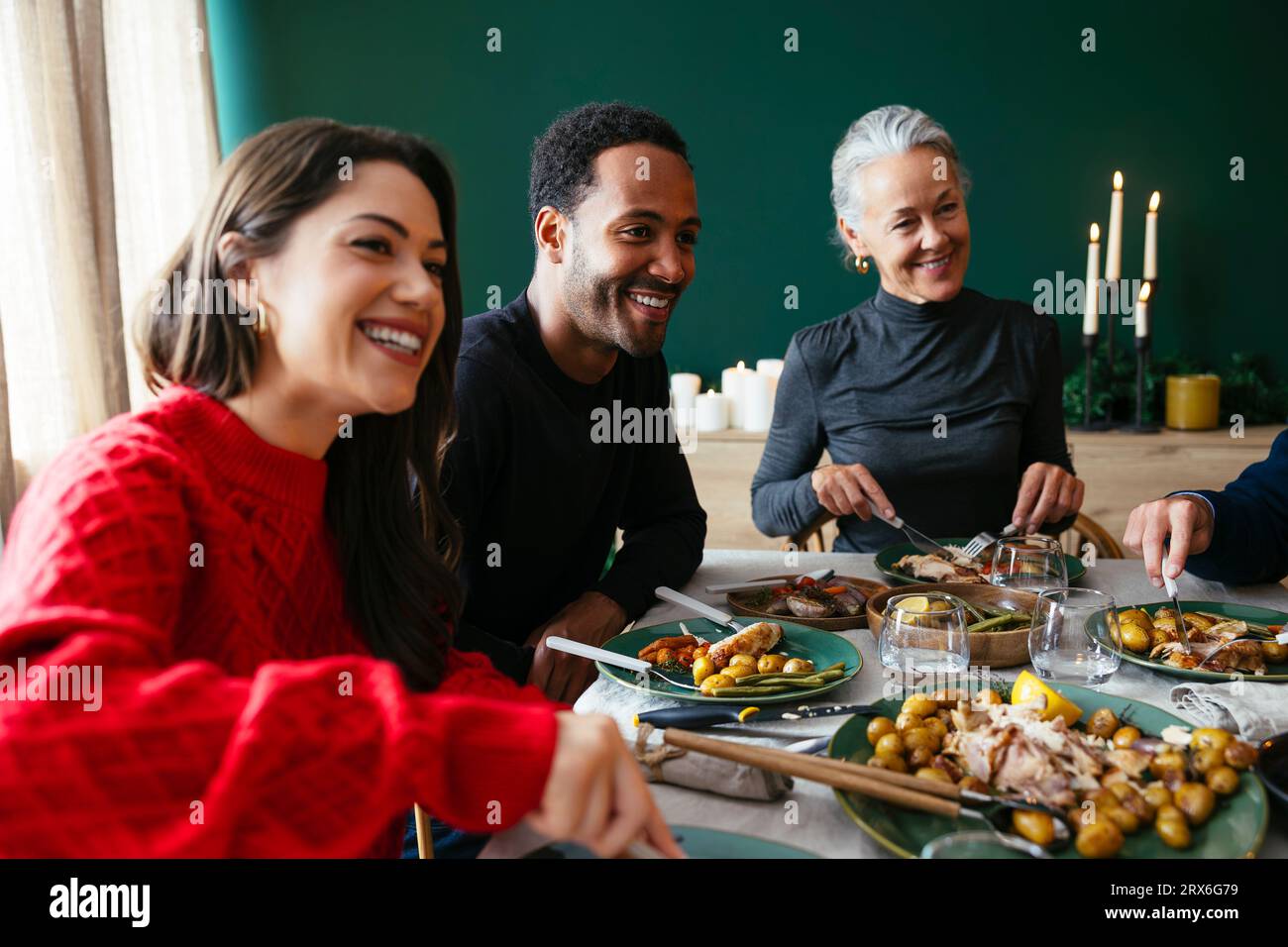 Smiling family having dinner together in dining room Stock Photo - Alamy