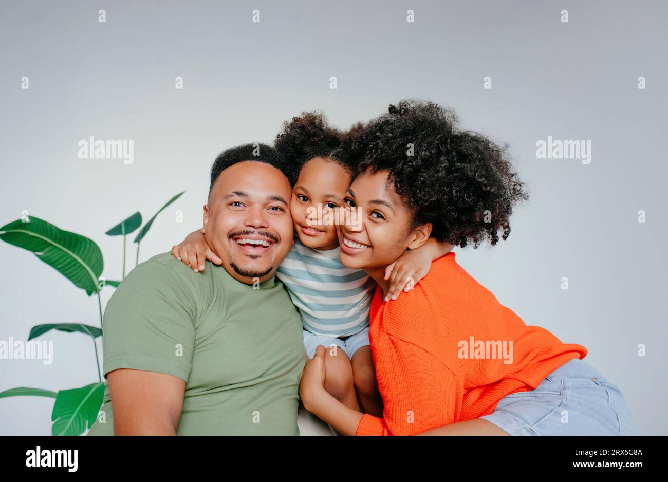 Playful daughter with parents against white background Stock Photo - Alamy