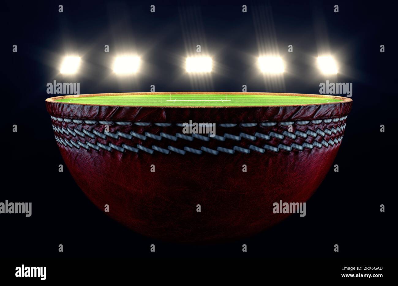 A cricket ball split in half revealing a marked green grass cricket ...