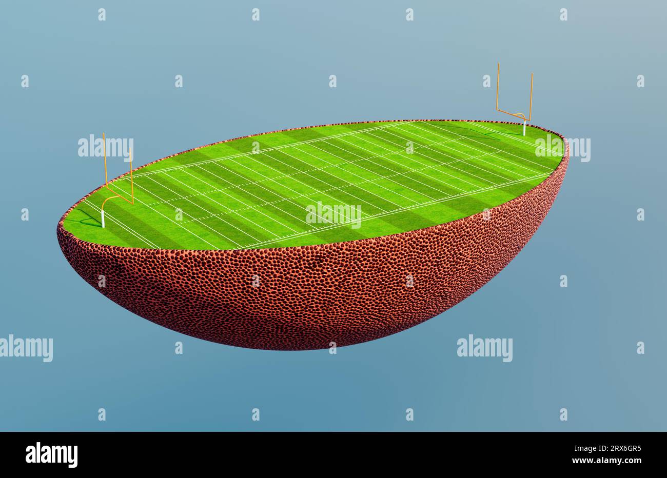 An american football ball split in half revealing a marked green grass ...