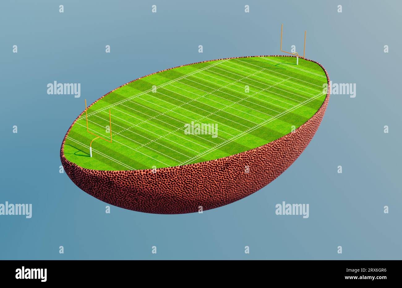 An american football ball split in half revealing a marked green grass ...