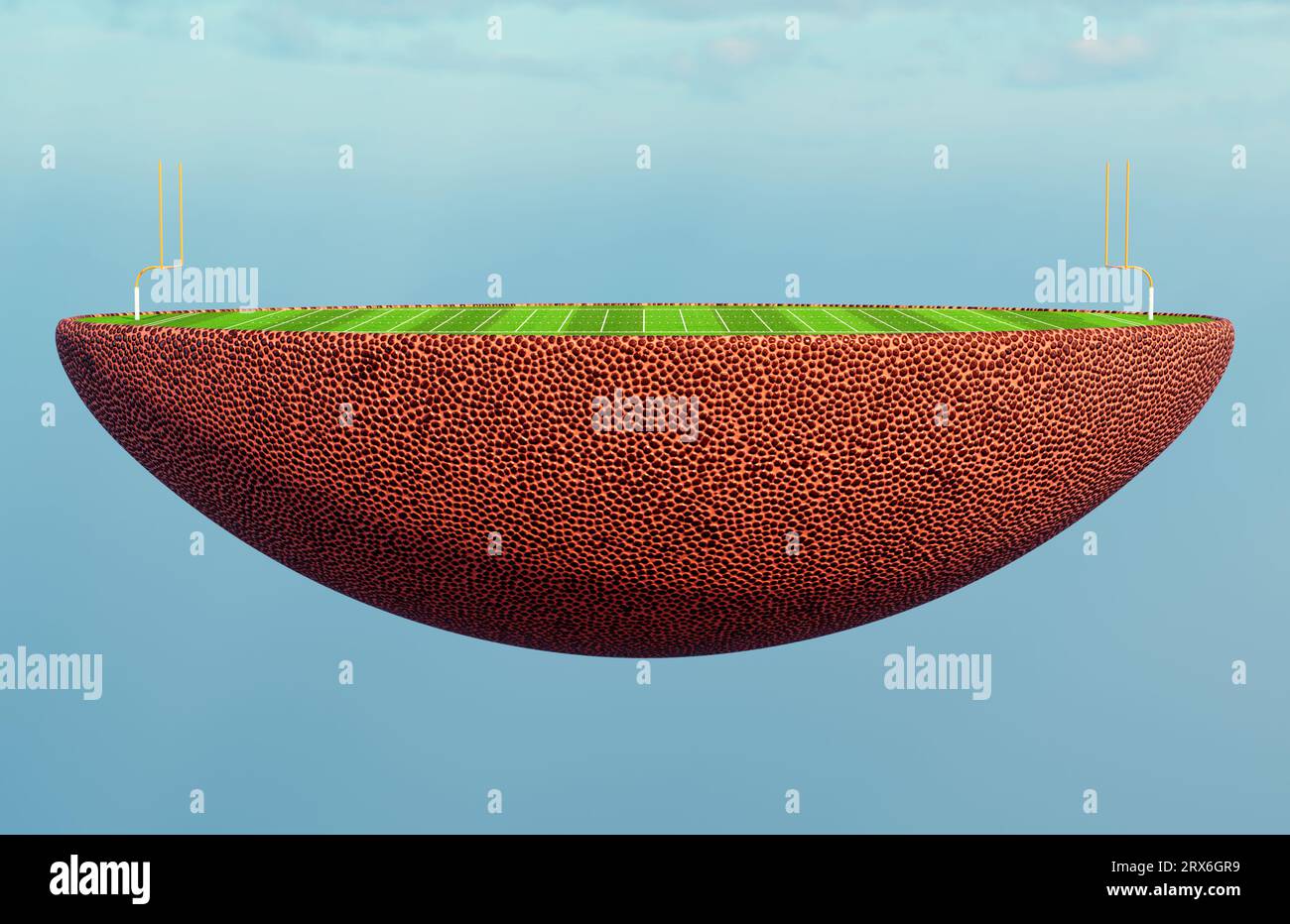 An american football ball split in half revealing a marked green grass ...