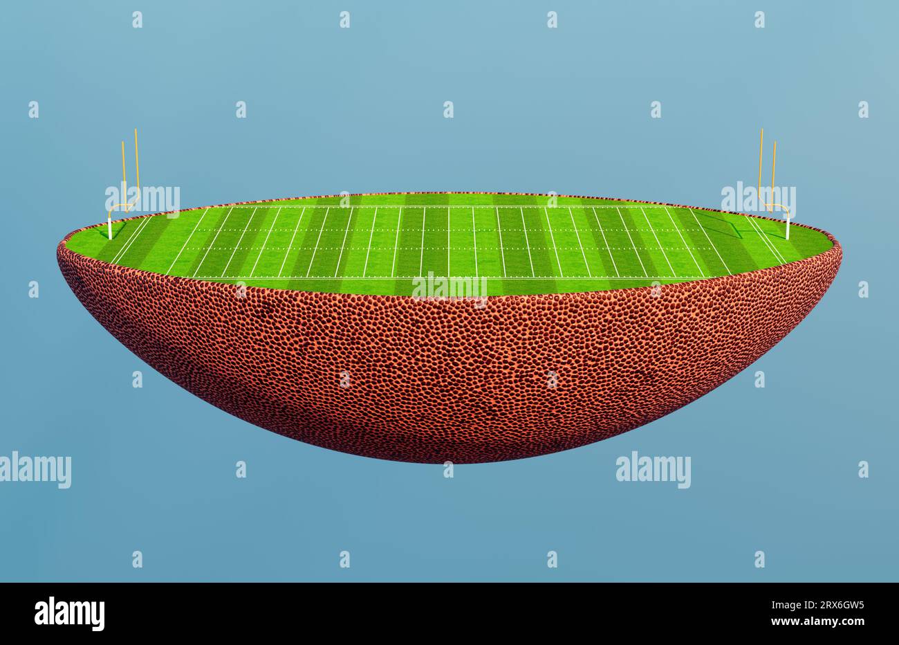 An american football ball split in half revealing a marked green grass ...