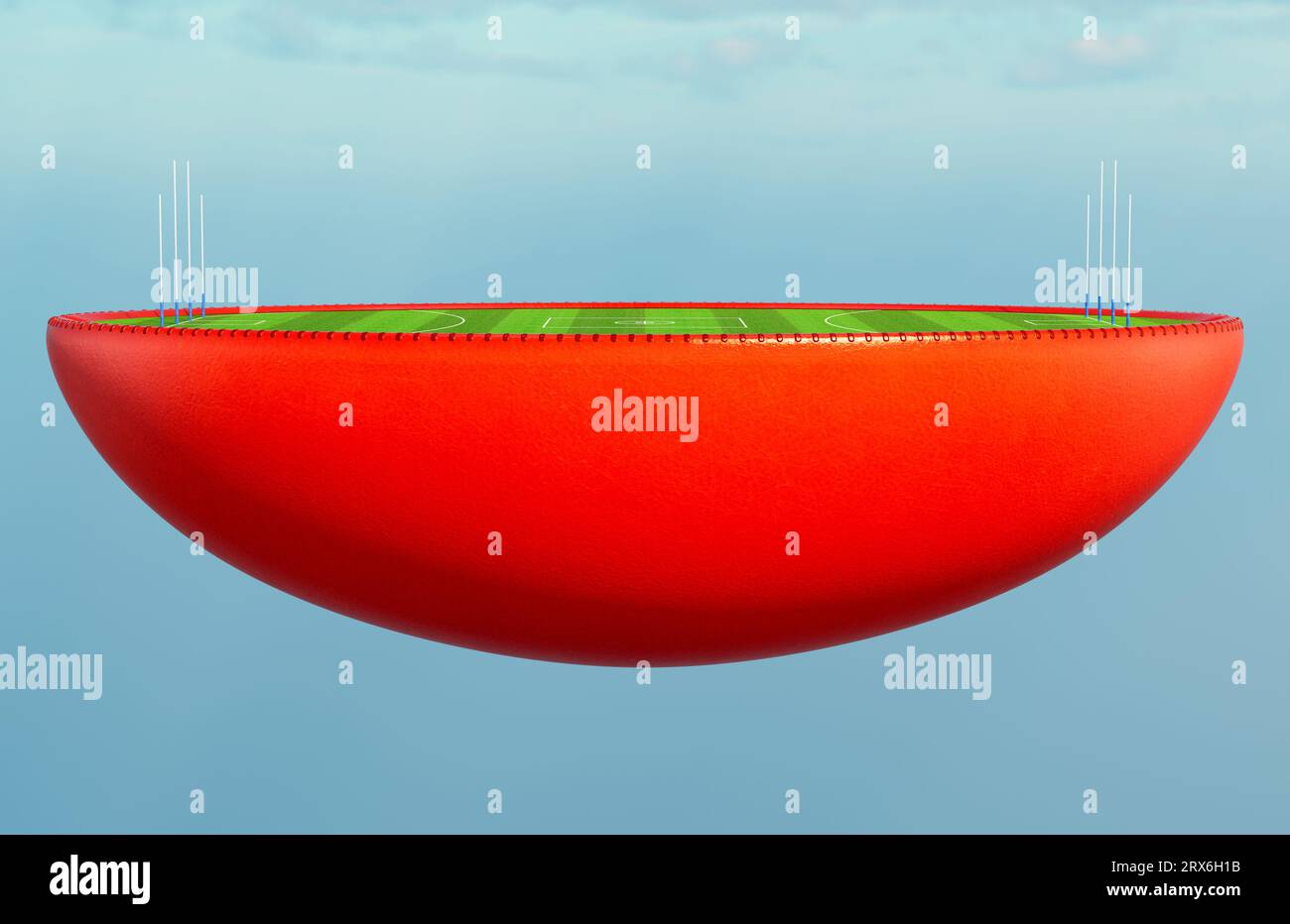 An ausralian rules ball split in half revealing a marked green grass ...