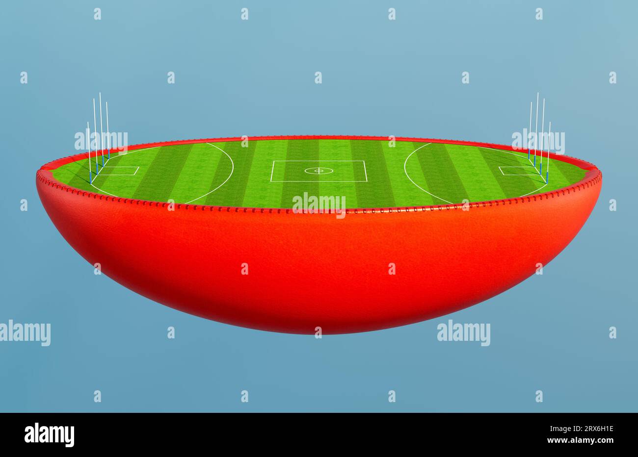 An ausralian rules ball split in half revealing a marked green grass ...