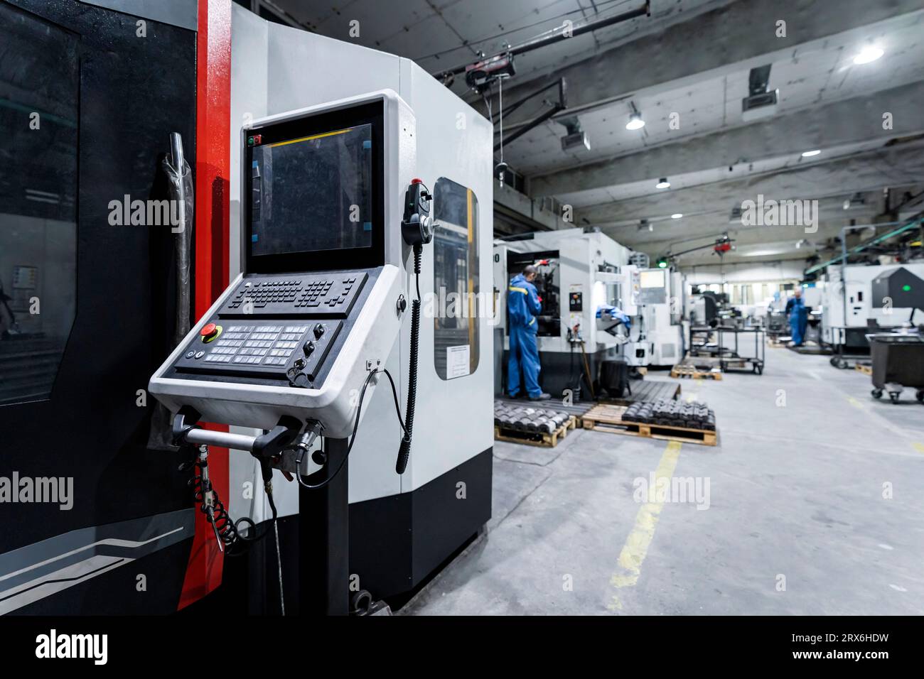 Technicians working and operating machinery in industry Stock Photo - Alamy