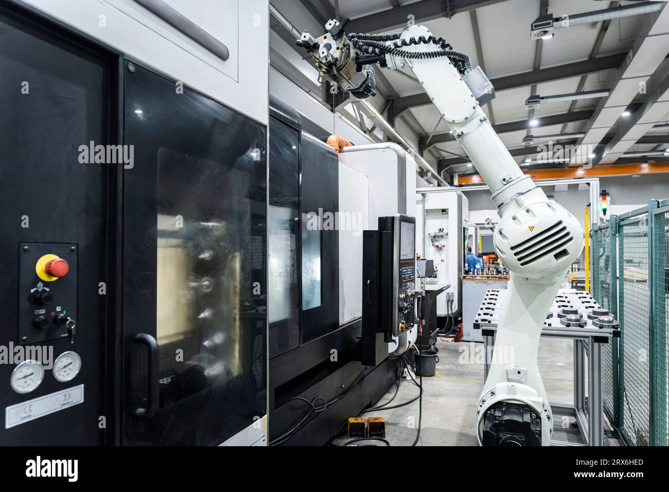 White robotic arm with cnc machinery in factory Stock Photo - Alamy