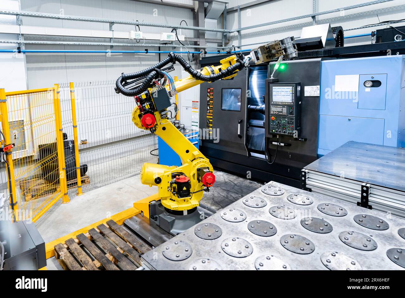 Yellow robotic arm with industrial machinery Stock Photo - Alamy