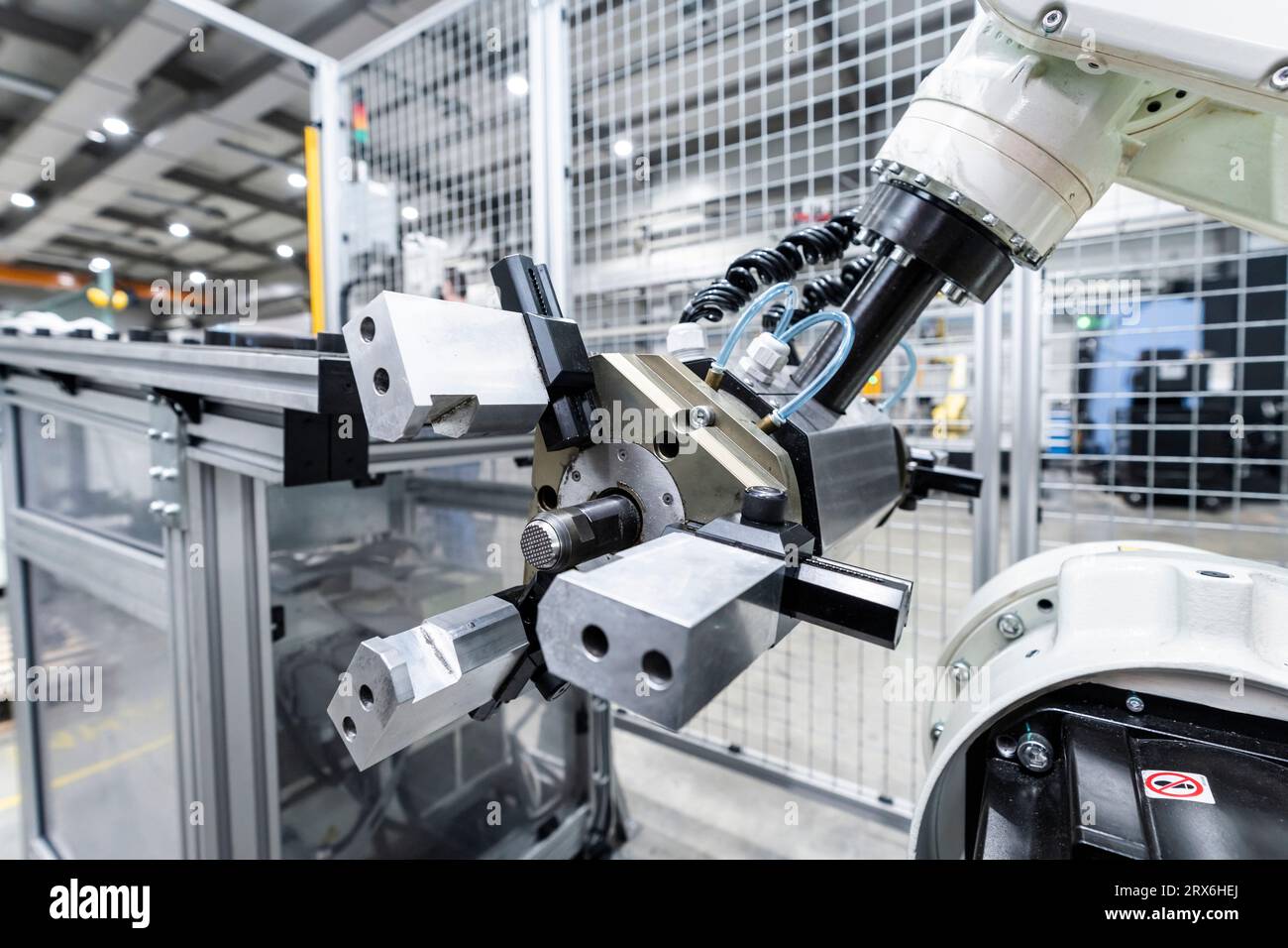 White robotic arm with machinery in factory Stock Photo - Alamy
