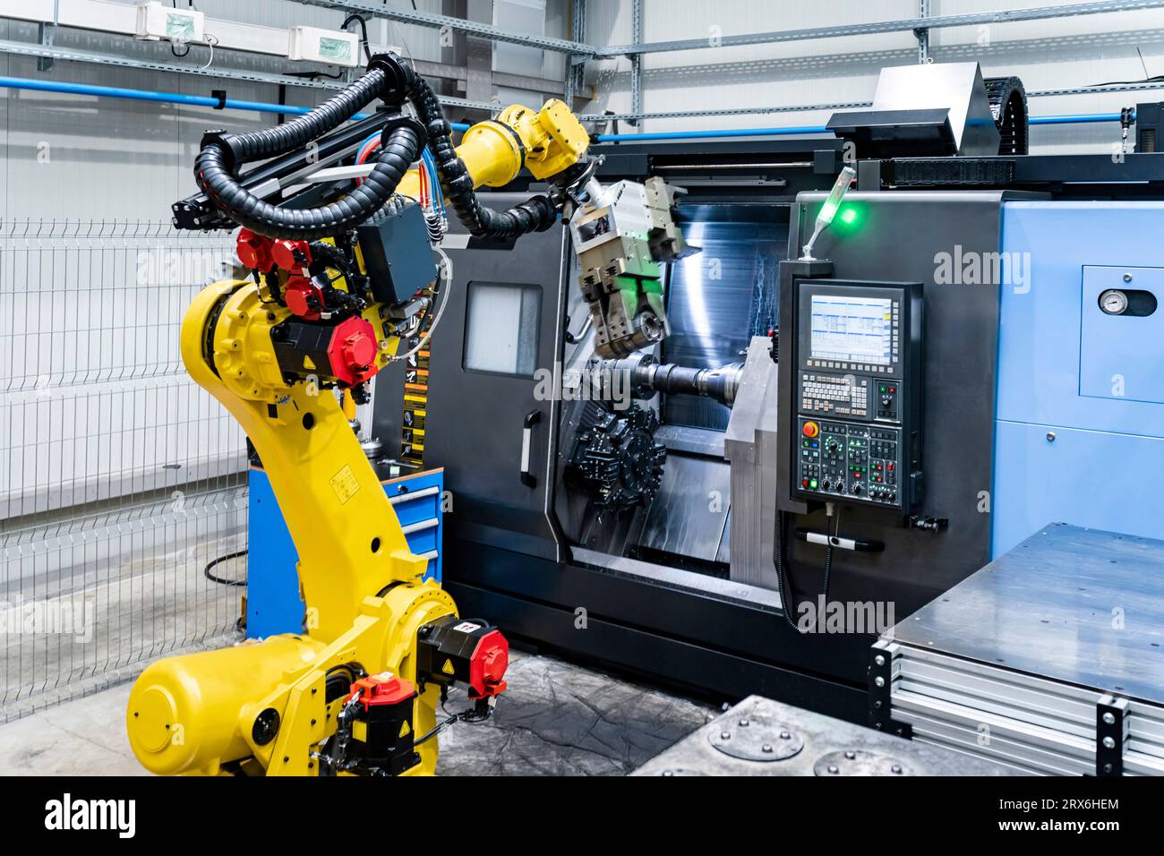 Yellow robotic arm with factory machinery Stock Photo - Alamy