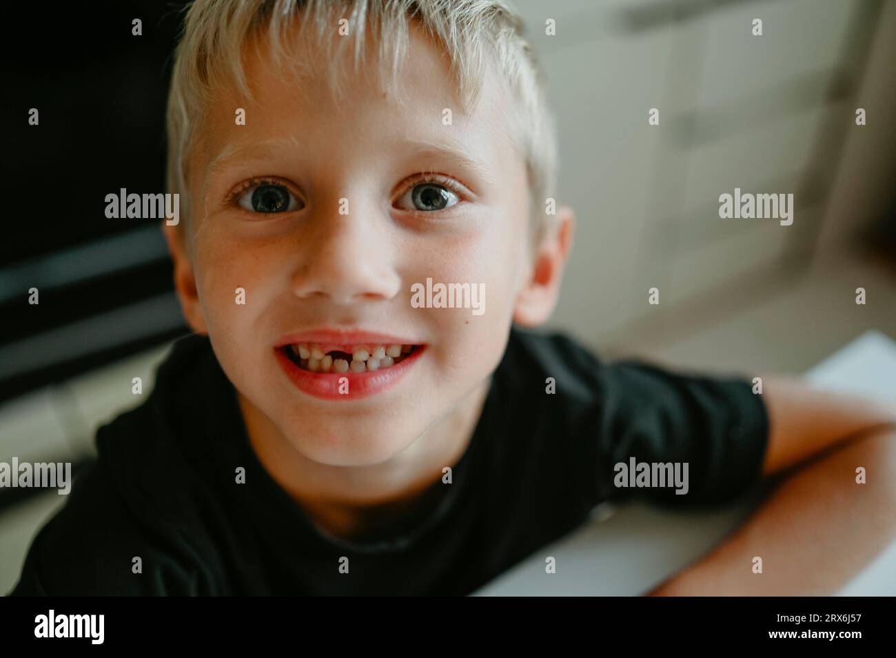 Smiling boy with gap tooth at home Stock Photo - Alamy
