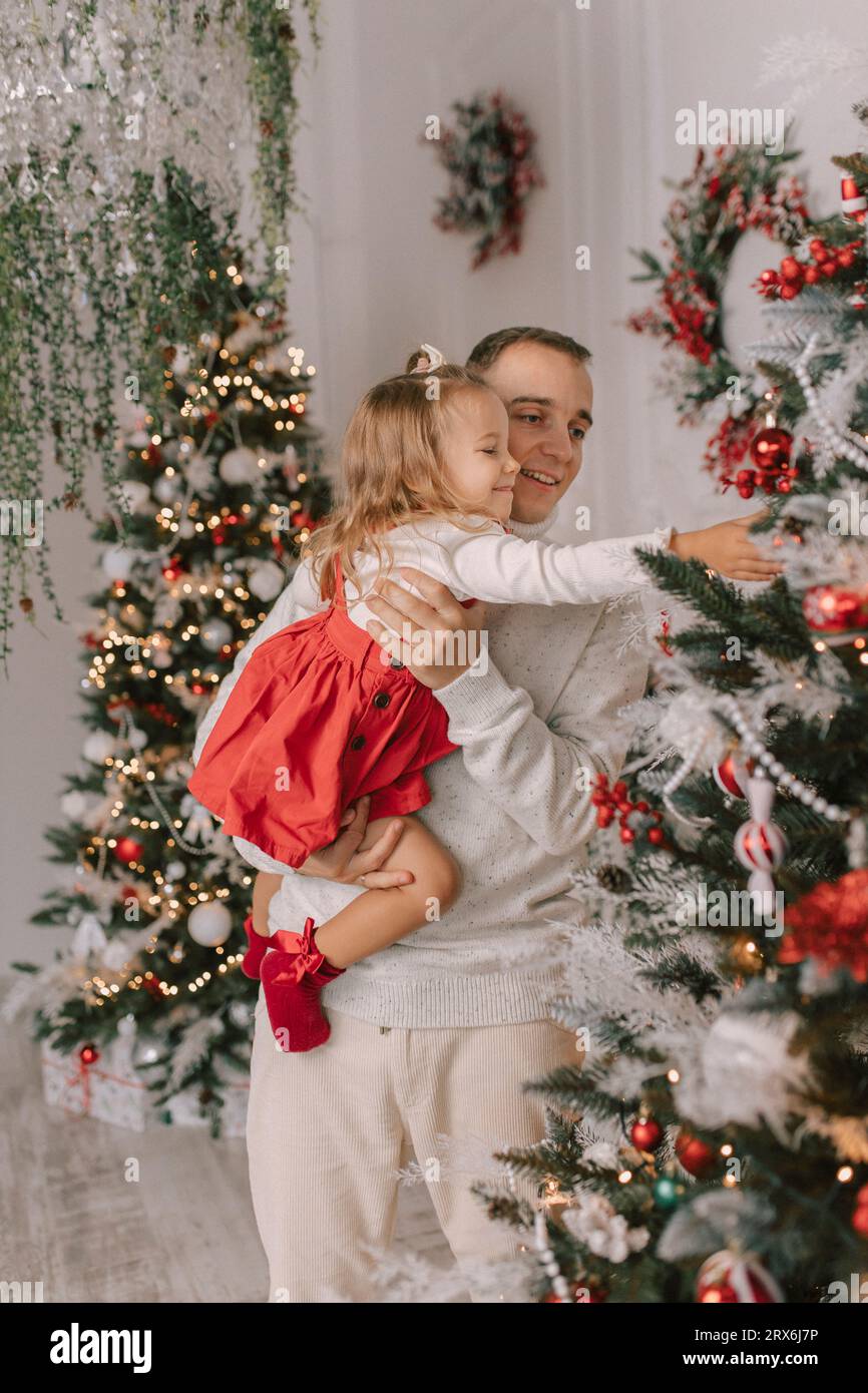 Children carrying christmas tree hi-res stock photography and images ...
